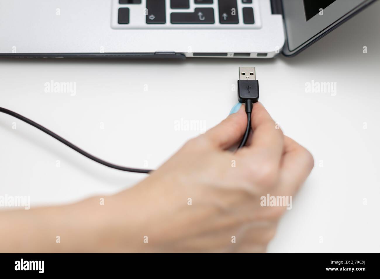 Female hand inserts cable hi-res stock photography and images - Alamy