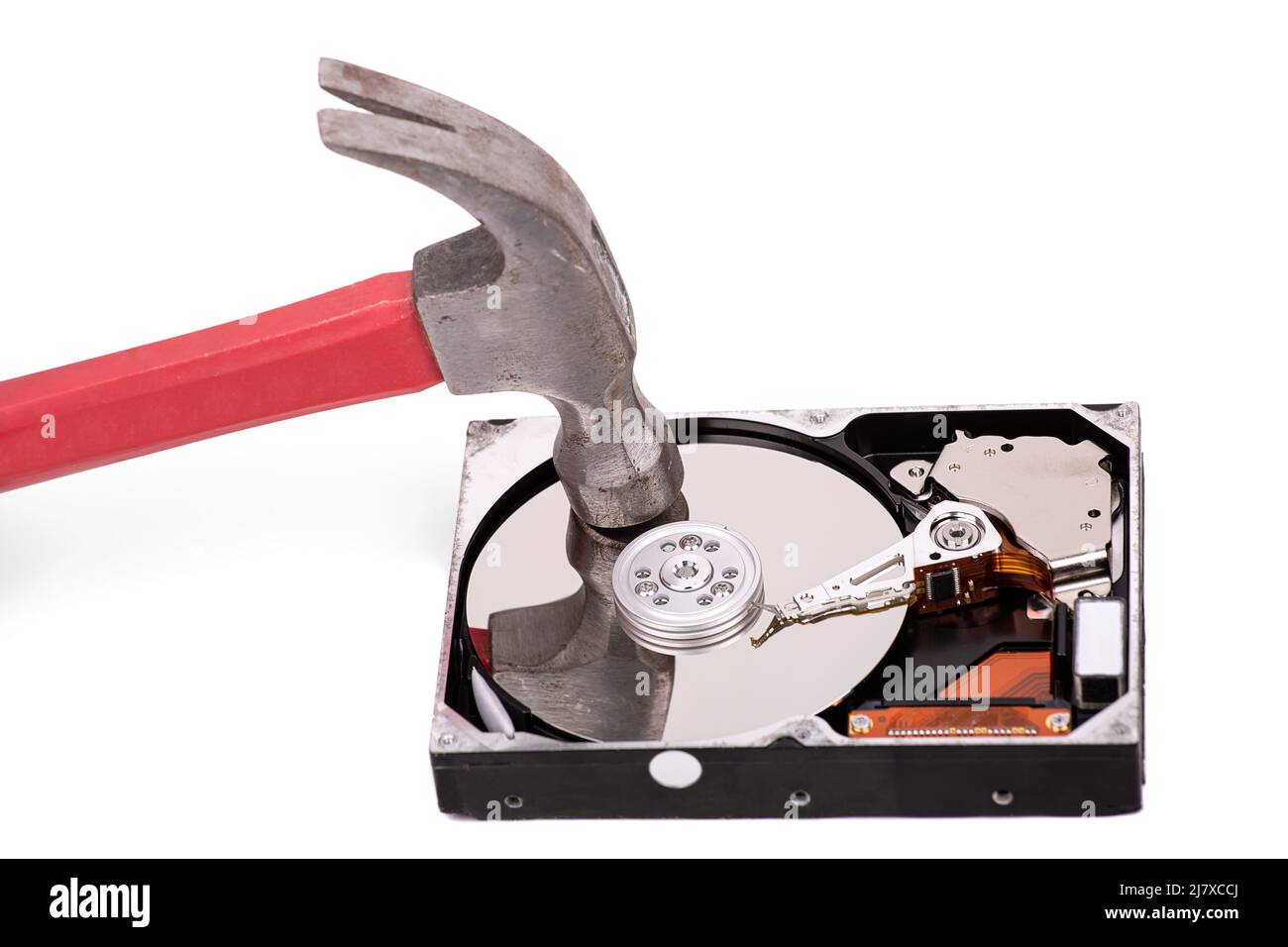 The hammer hits the plate of an open hard drive. Destruction of ...