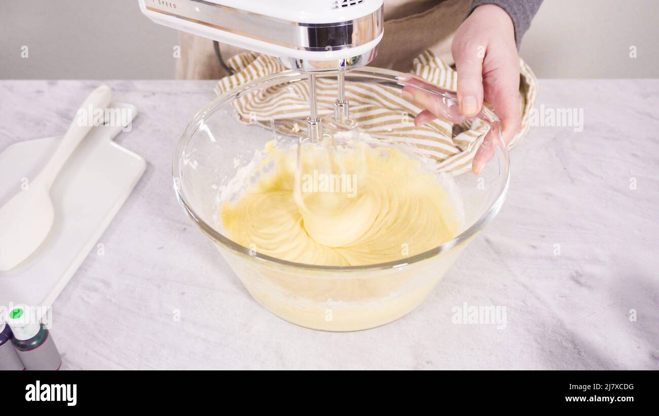 Step by step. Mixing ingredient in a mixing bowl with an electric mixer ...
