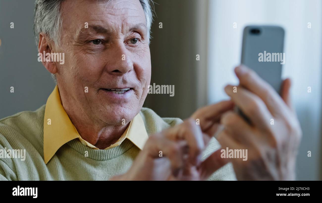 Active positive senior man make video call hold smartphone elderly male ...