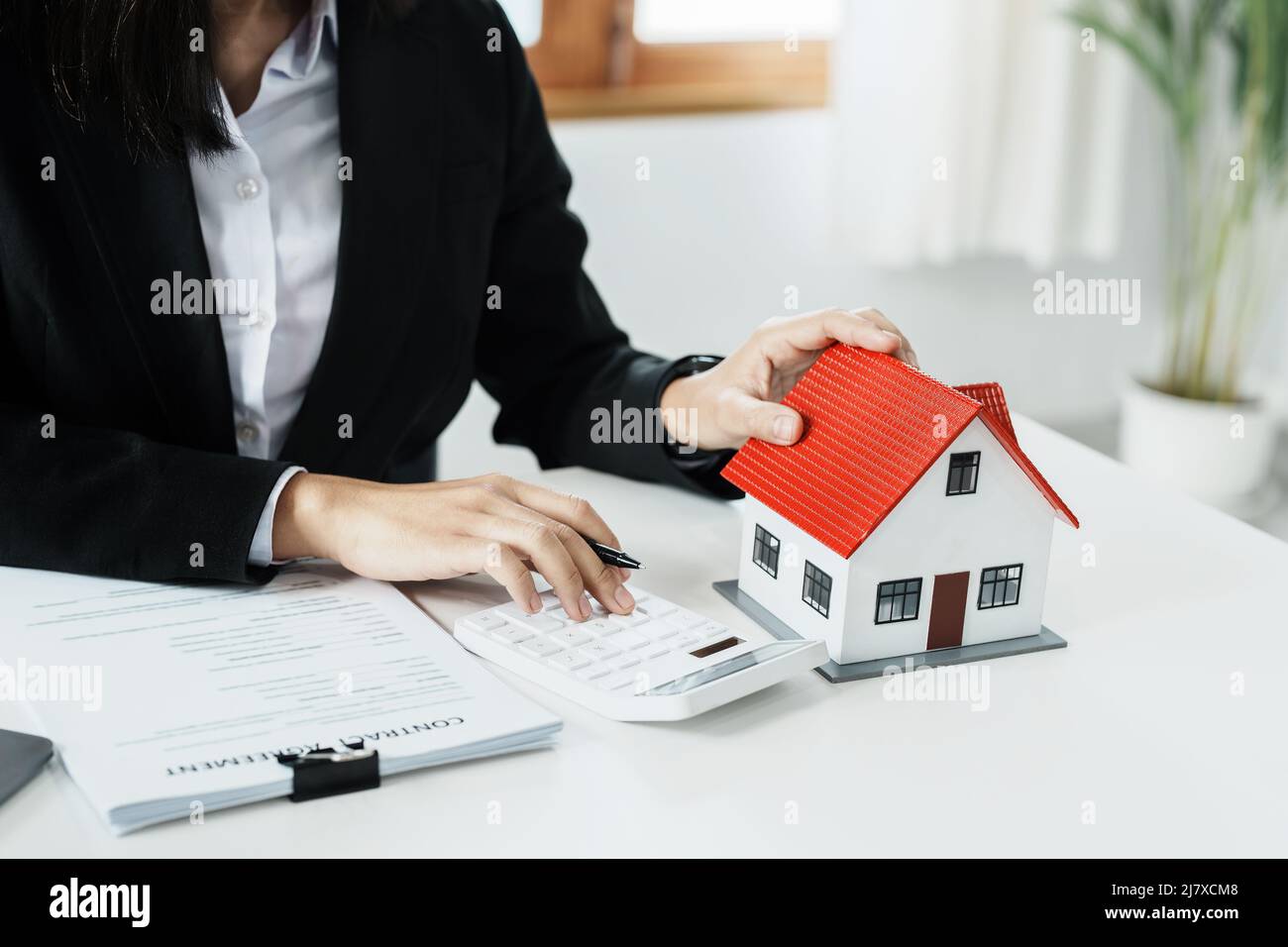 Entrepreneurs, business owners, accountants, real estate agents, A young woman uses a calculator ...