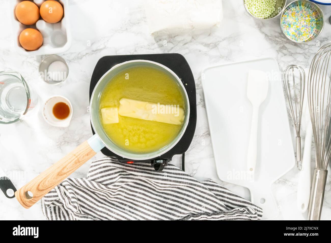 Melting butter sticks in a saucepan for baking a cake Stock Photo - Alamy