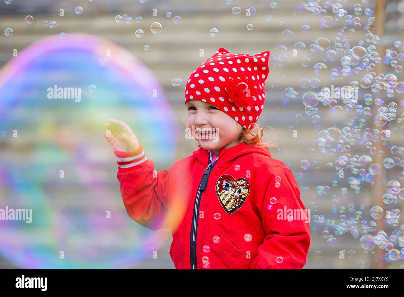 a little smiling girl in soap bubbles Stock Photo - Alamy