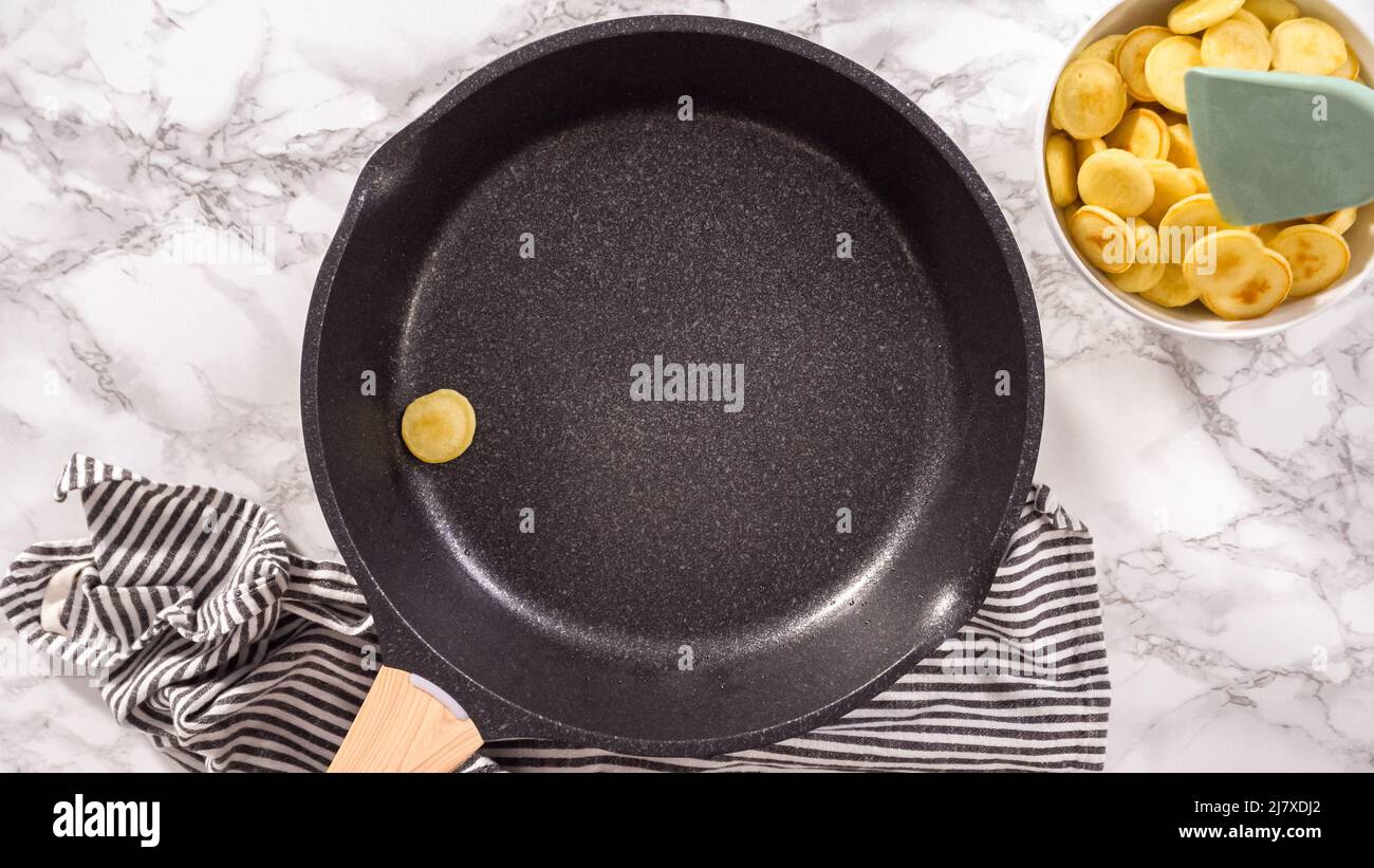 Flat lay. Step by step. Frying mini pancake cereal in a nonstick frying ...