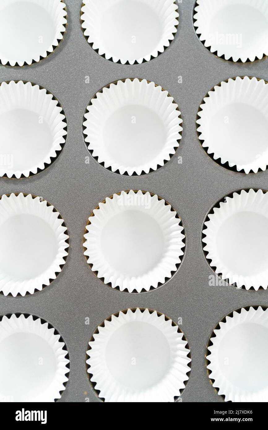 Lining cupcake pan with foil cupcake liners to bake s'mores cupcakes ...
