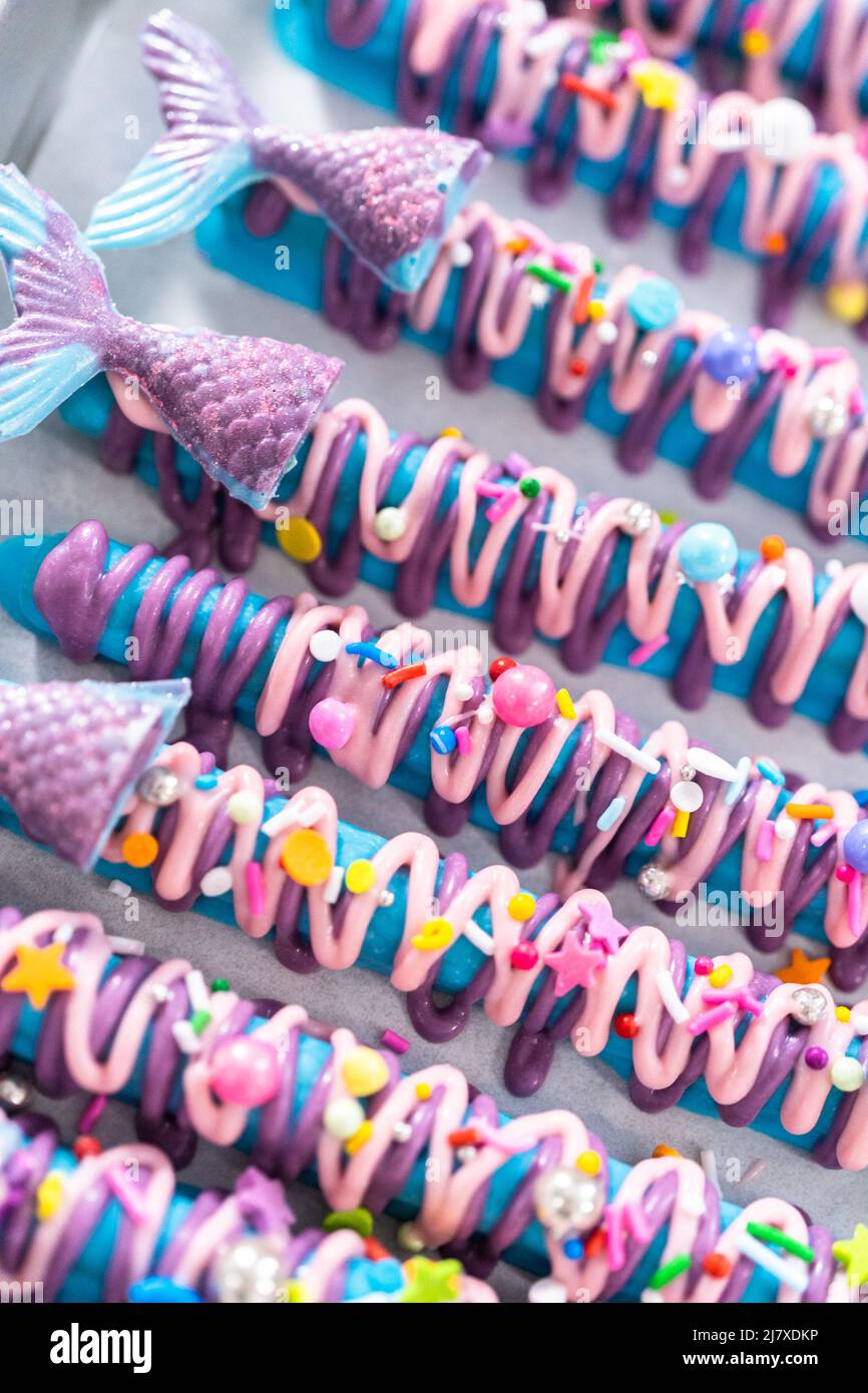 Mermaid chocolate pretzel rods drizzled with pink and purple chocolate ...