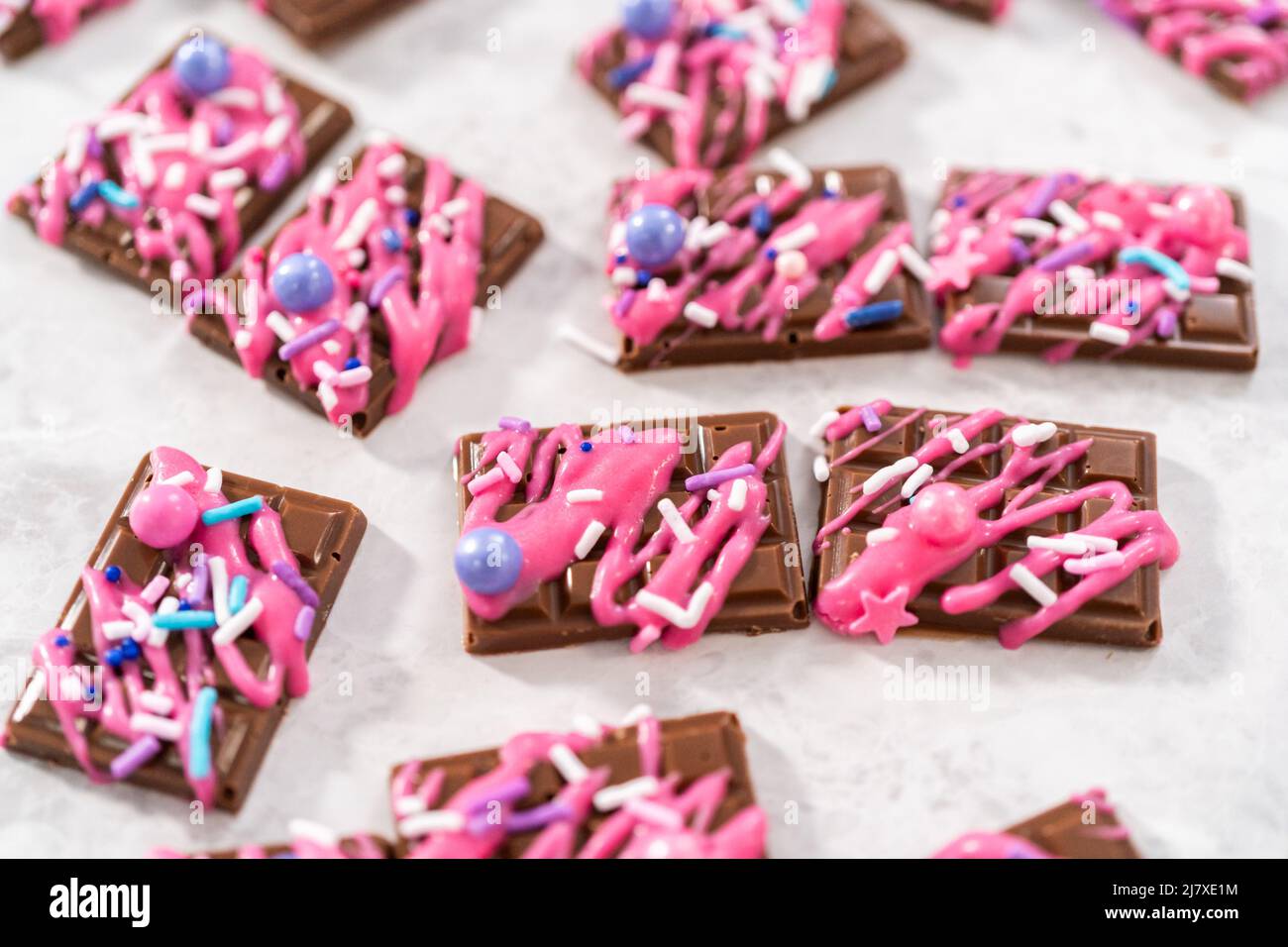 Gourmet dark mini chocolates with drizzled pink chocolate and fancy ...