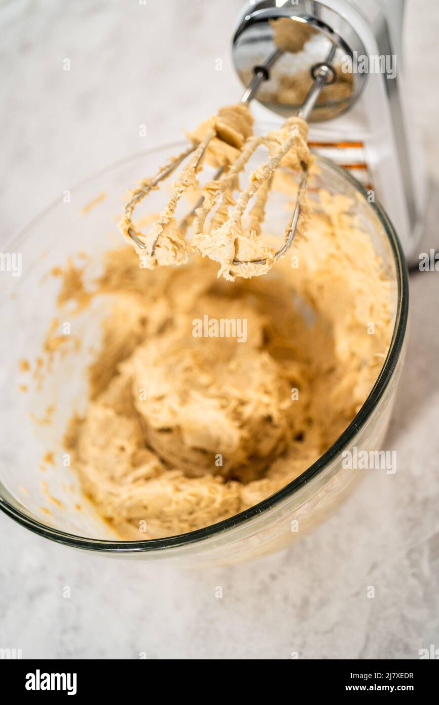 Mixing ingredients in a large glass mixing bowl to bake eggnog scones ...