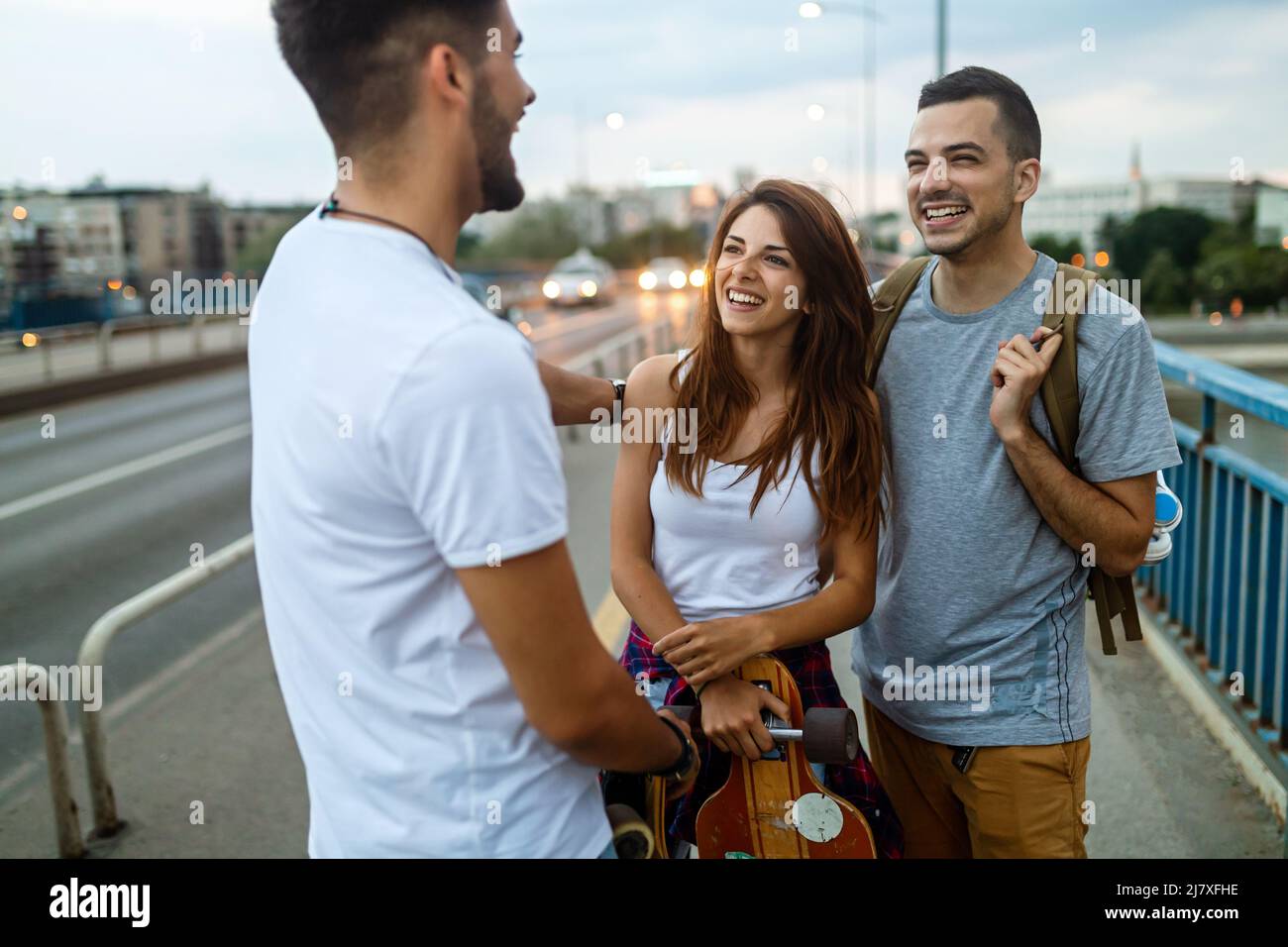 Group of happy teen people hang out together and enjoying skateboard ...