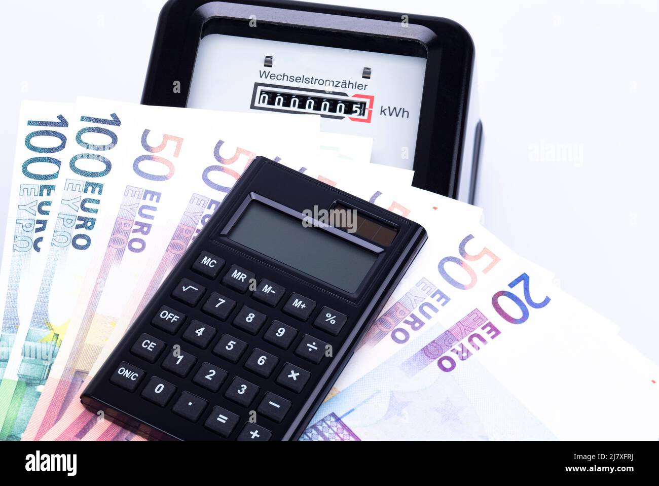 The photo shows an AC electricity counter with euro bills and a ...
