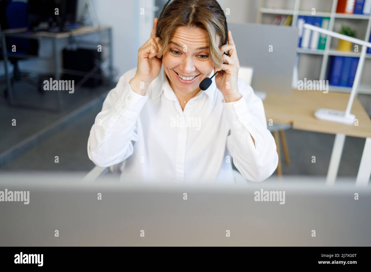 Positive call center operator talking hi-res stock photography and ...