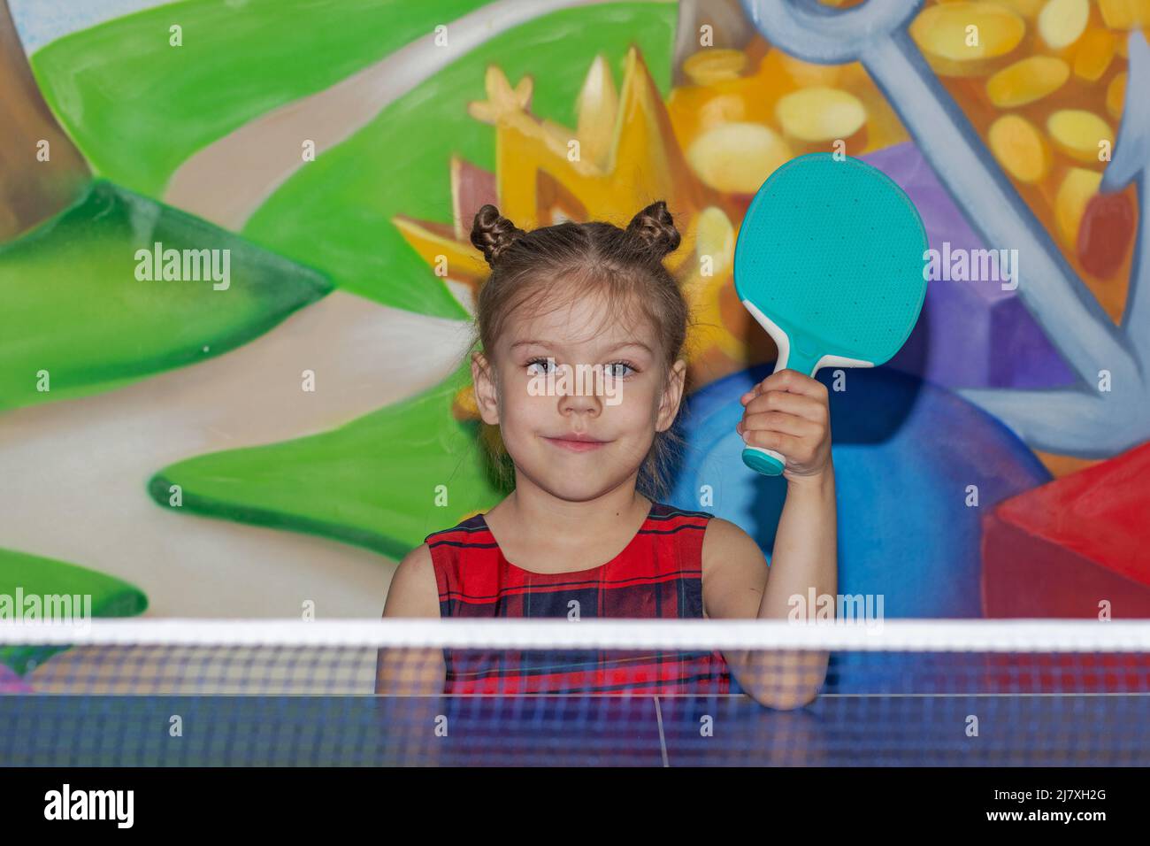 Happy child holding ping pong racket Stock Photo - Alamy