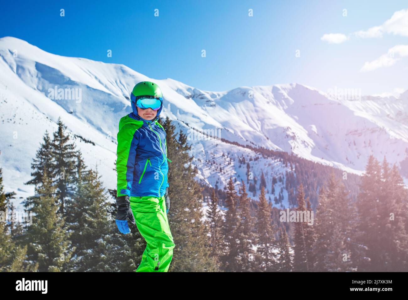 Boy in ski or snowboard outfit stand over the snow mountain Stock Photo ...