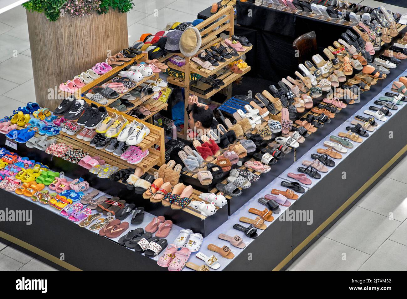 Overhead view of shoe sale counter with sales person surrounded by ...
