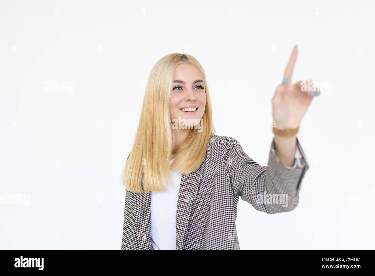 Portrait of a pretty girl pointing finger away isolated on a white ...