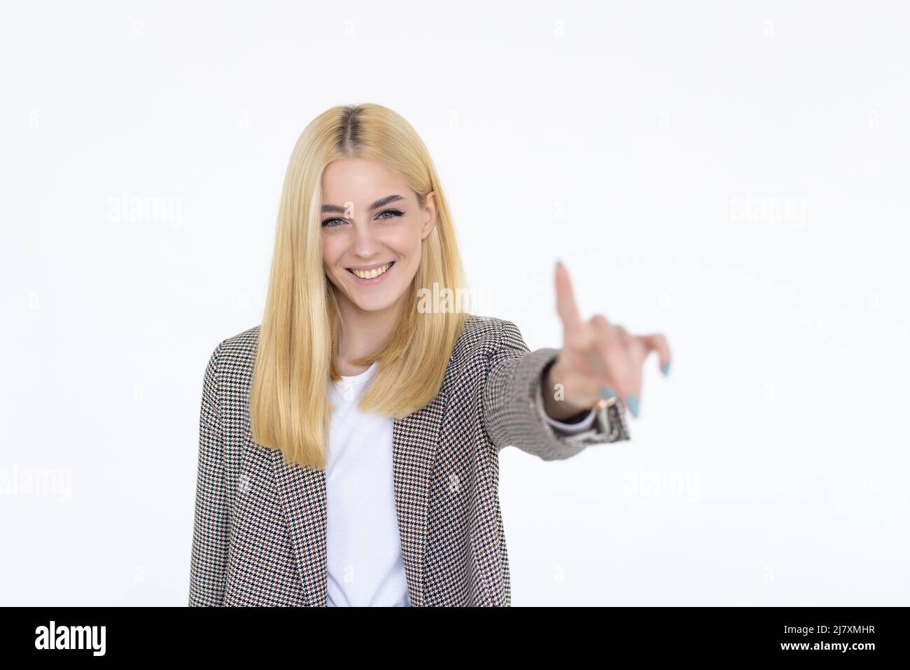 Portrait of a pretty girl pointing finger away isolated on a white ...