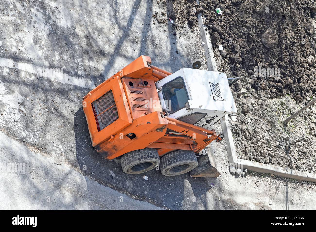 Wheeled mini loader working on urban landscaping, top view Stock Photo ...