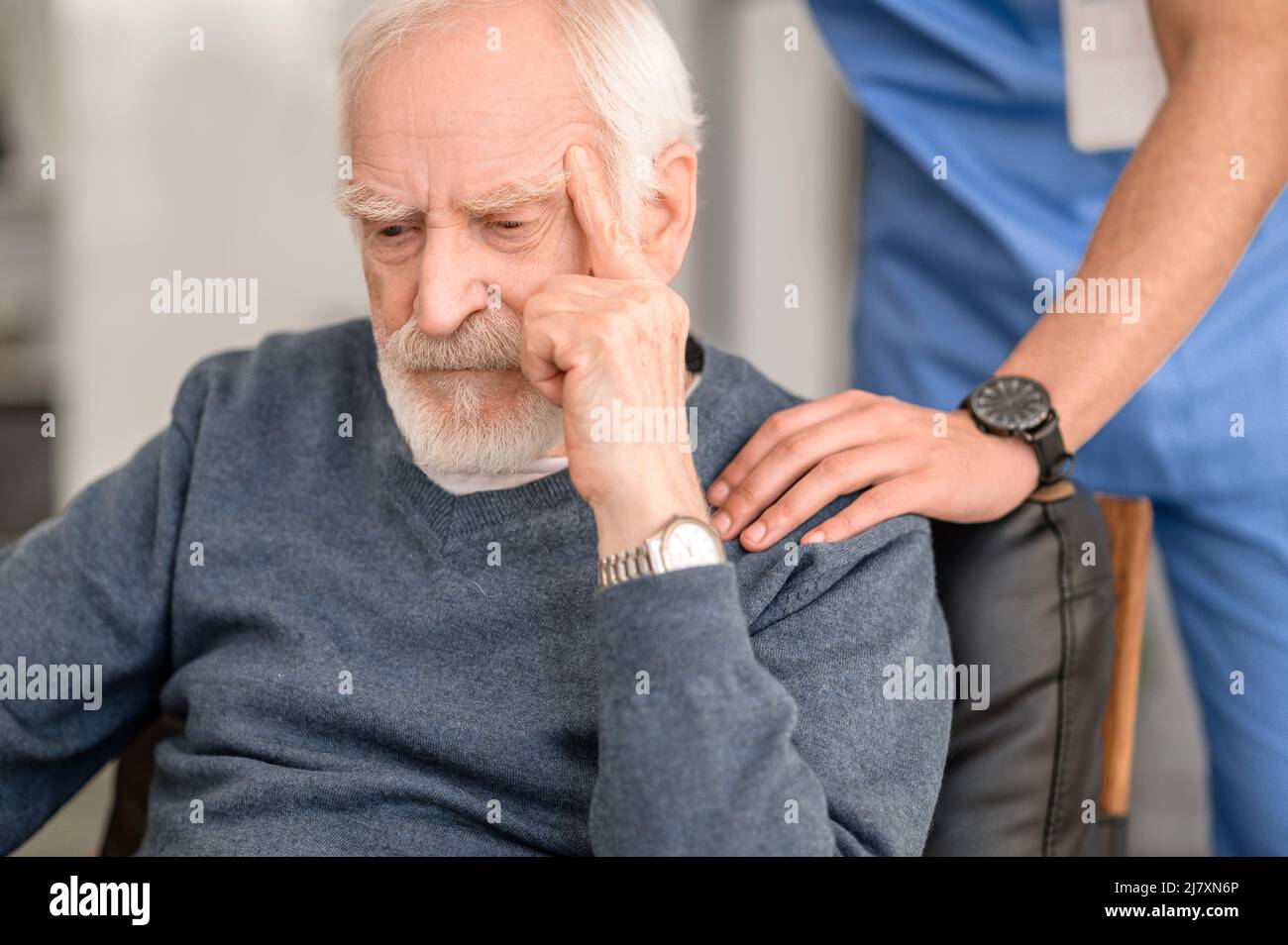 Low-spirited elderly person comforted by his caregiver Stock Photo - Alamy