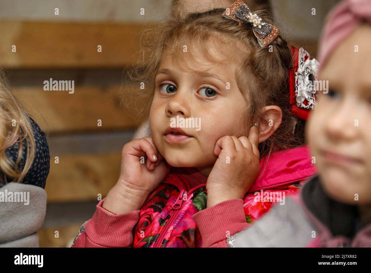 ODESA, UKRAINE - MAY 7, 2022 - A little girl covers her ears as actors ...