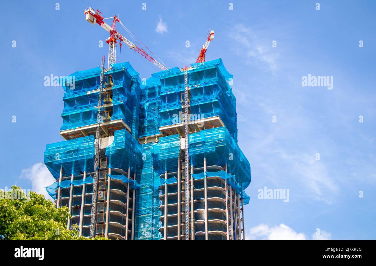 Two multistory buildings, the facade is covered with protective ...