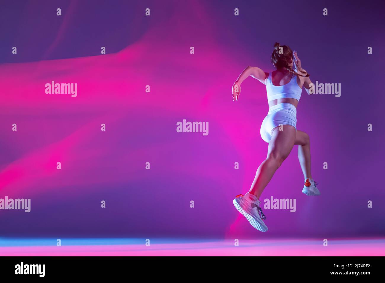 back view. Professional female athlete, runner training isolated on ...