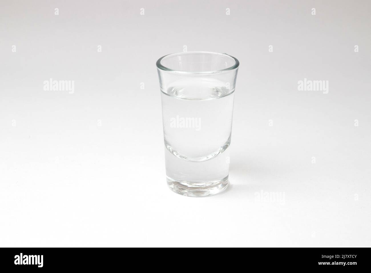 Glass with transparent liquid alcohol on a white background Stock Photo ...