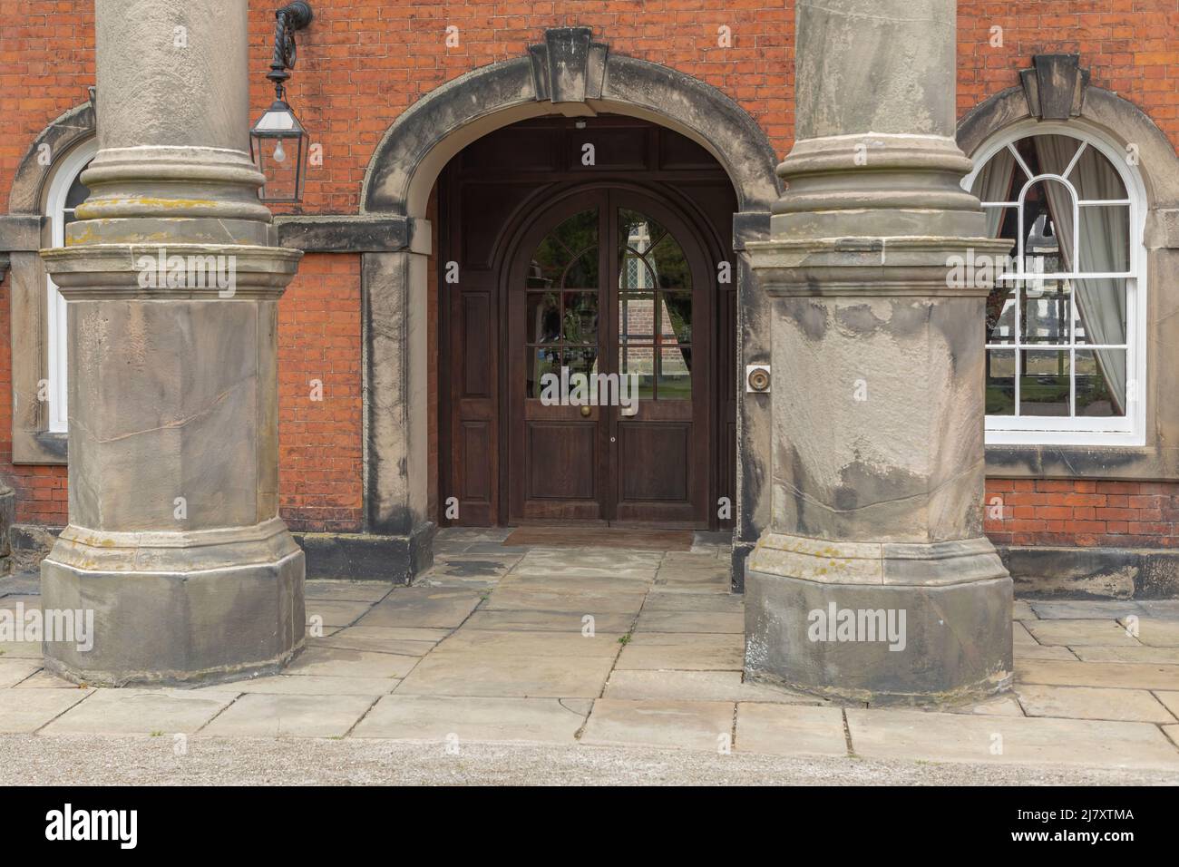 The grand entrance with magnificent pillar entering into a stately home ...