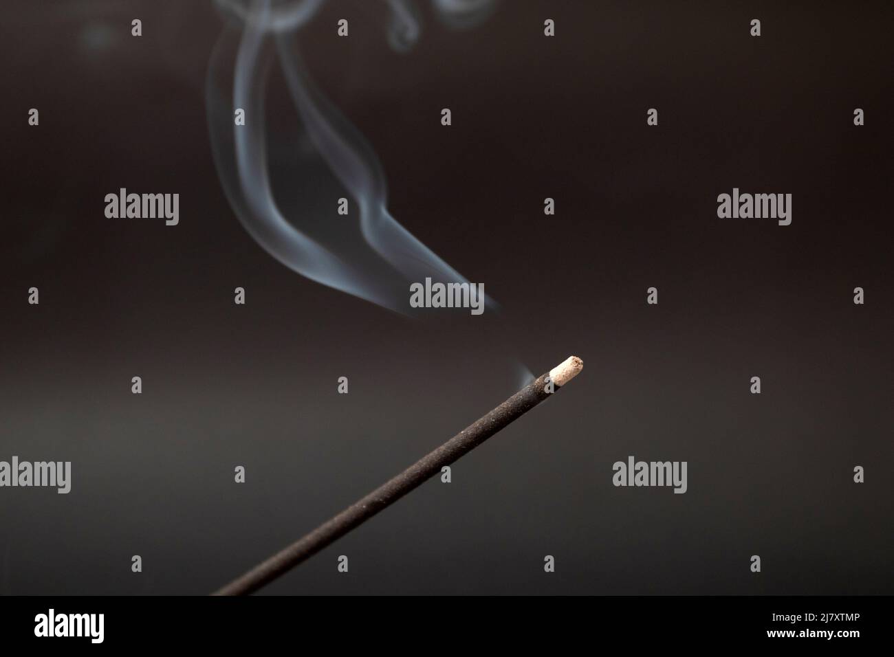 incense smoking stick on a black background Stock Photo - Alamy