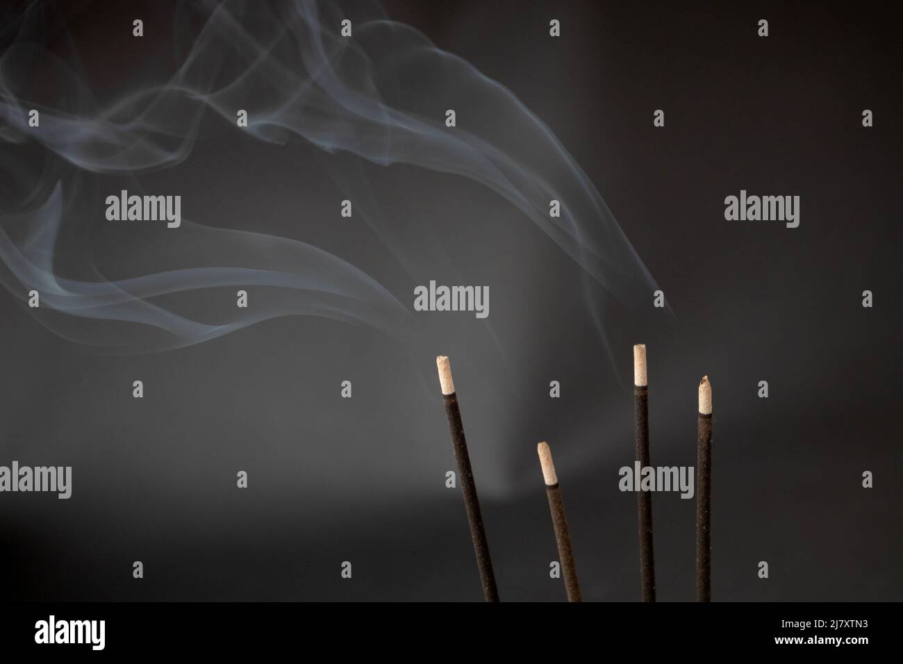 Burning aromatic incense sticks with fume on black background Stock ...