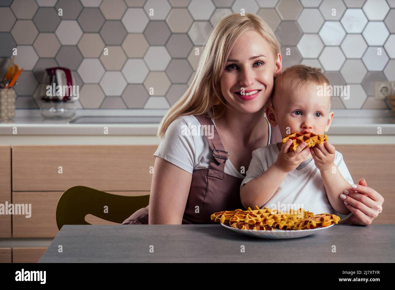 caucasian family together cooking kitchen.boy and mother eating Belgian ...