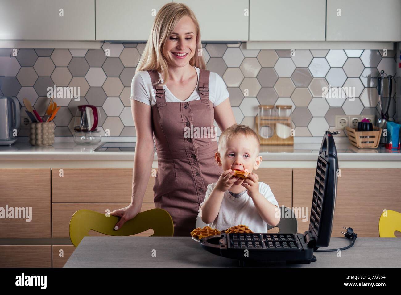 caucasian family together cooking kitchen.boy and mother eating Belgian ...