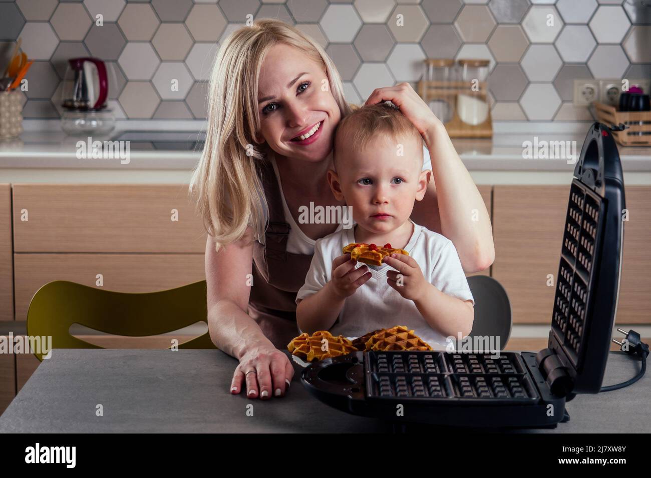 caucasian family together cooking kitchen.boy and mother eating Belgian ...