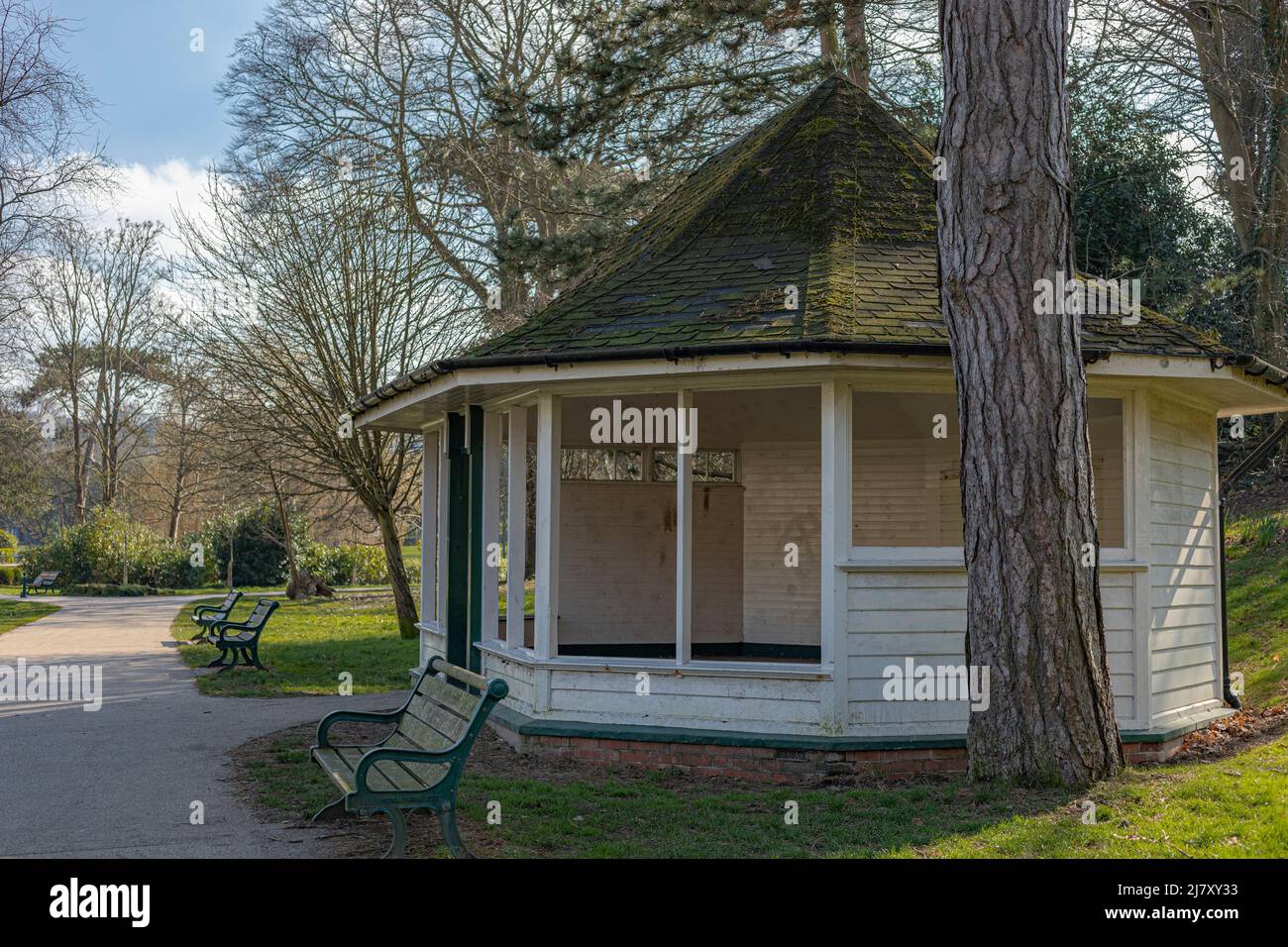 White painted wooden bandstand type shelter located in a park with ...