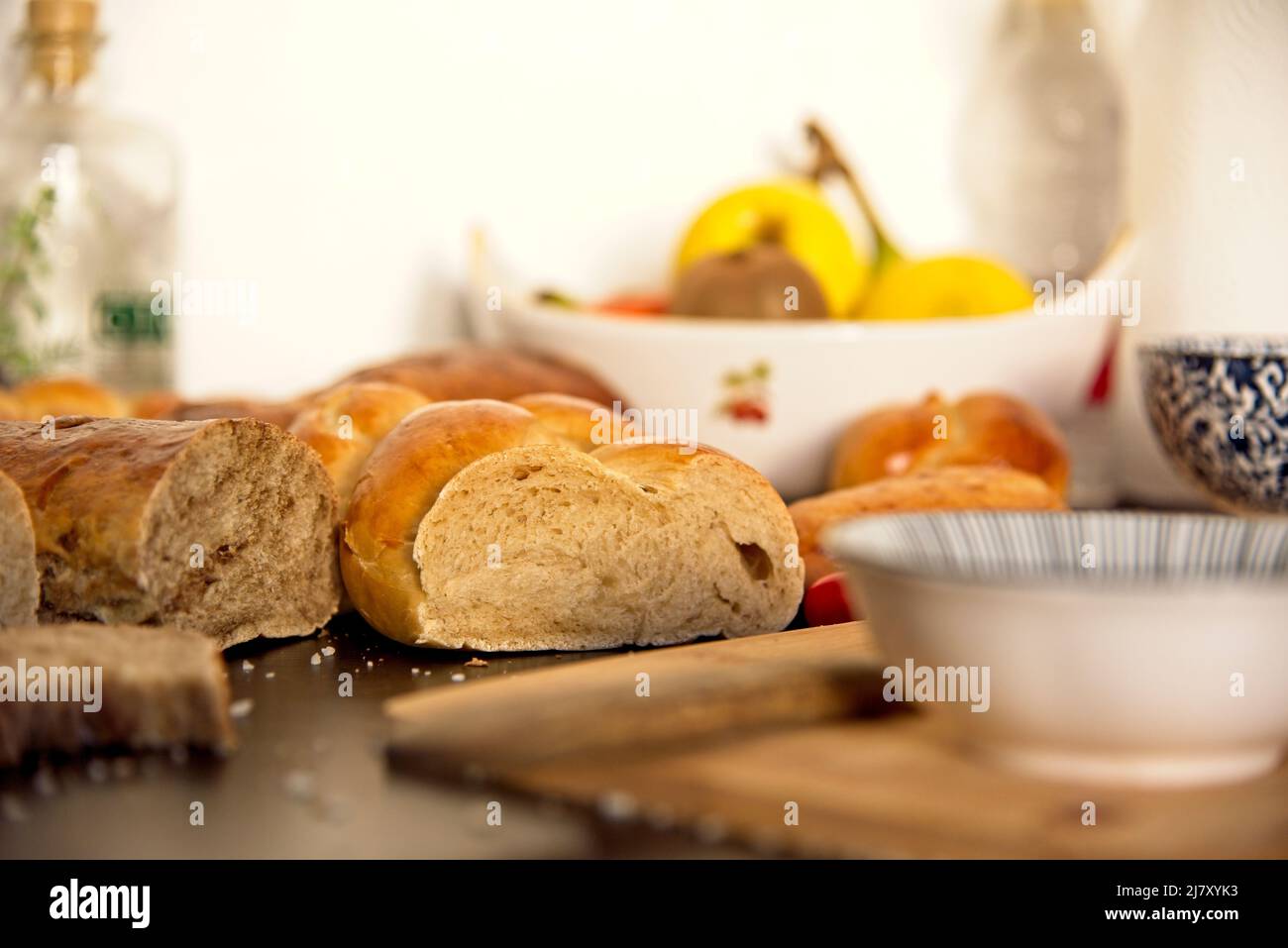 Feast, messy table. Bread in the shape of a braid. Sweet Challah ...