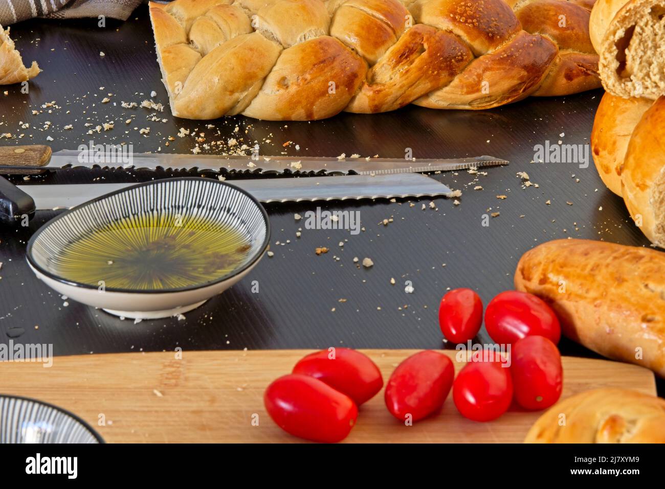 Feast, messy table. Bread in the shape of a braid. Sweet Challah ...