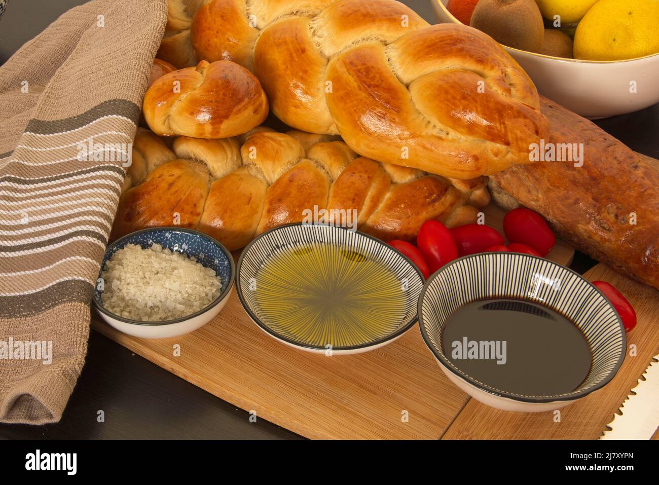 Feast, messy table. Bread in the shape of a braid. Sweet Challah ...