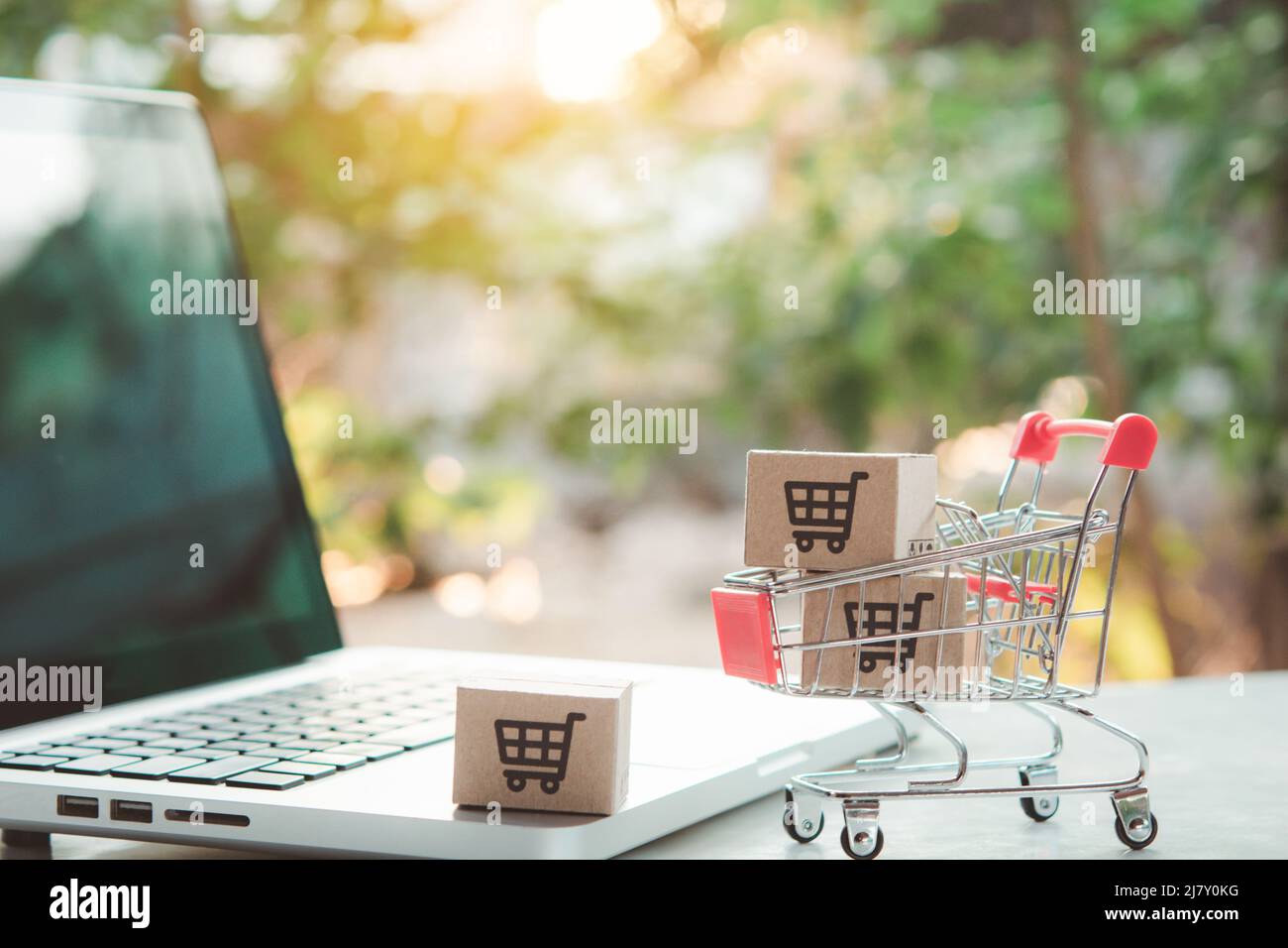 Shopping online. cardboard box with a shopping cart logo in a trolley ...