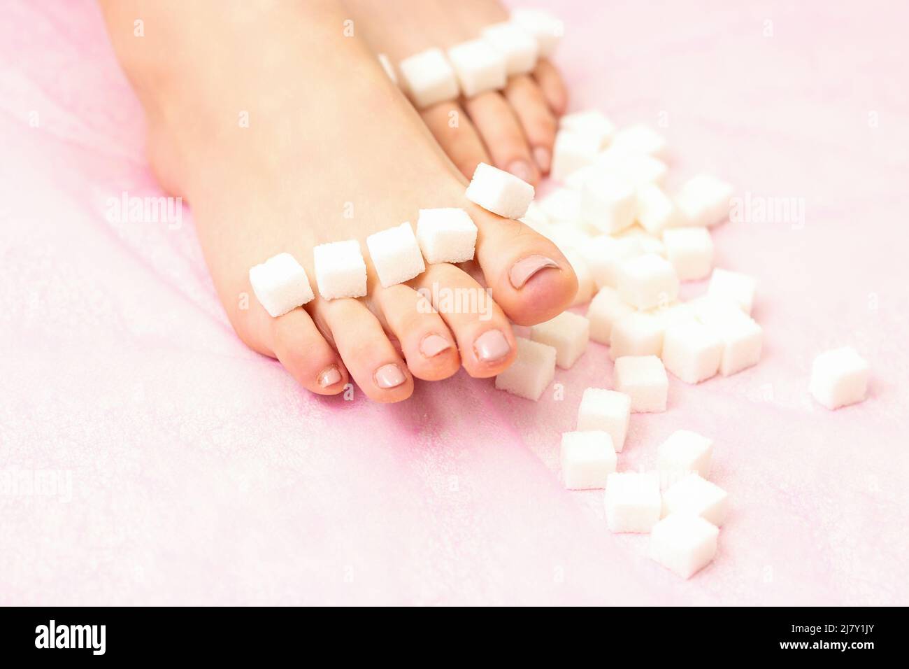 The concept of epilation, waxing. Sugar cubes lying down in a row on ...