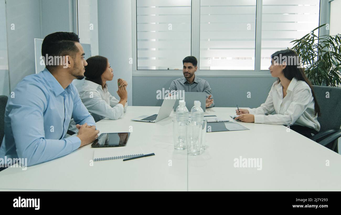 Business people sitting at conference table. Confident arabic ...