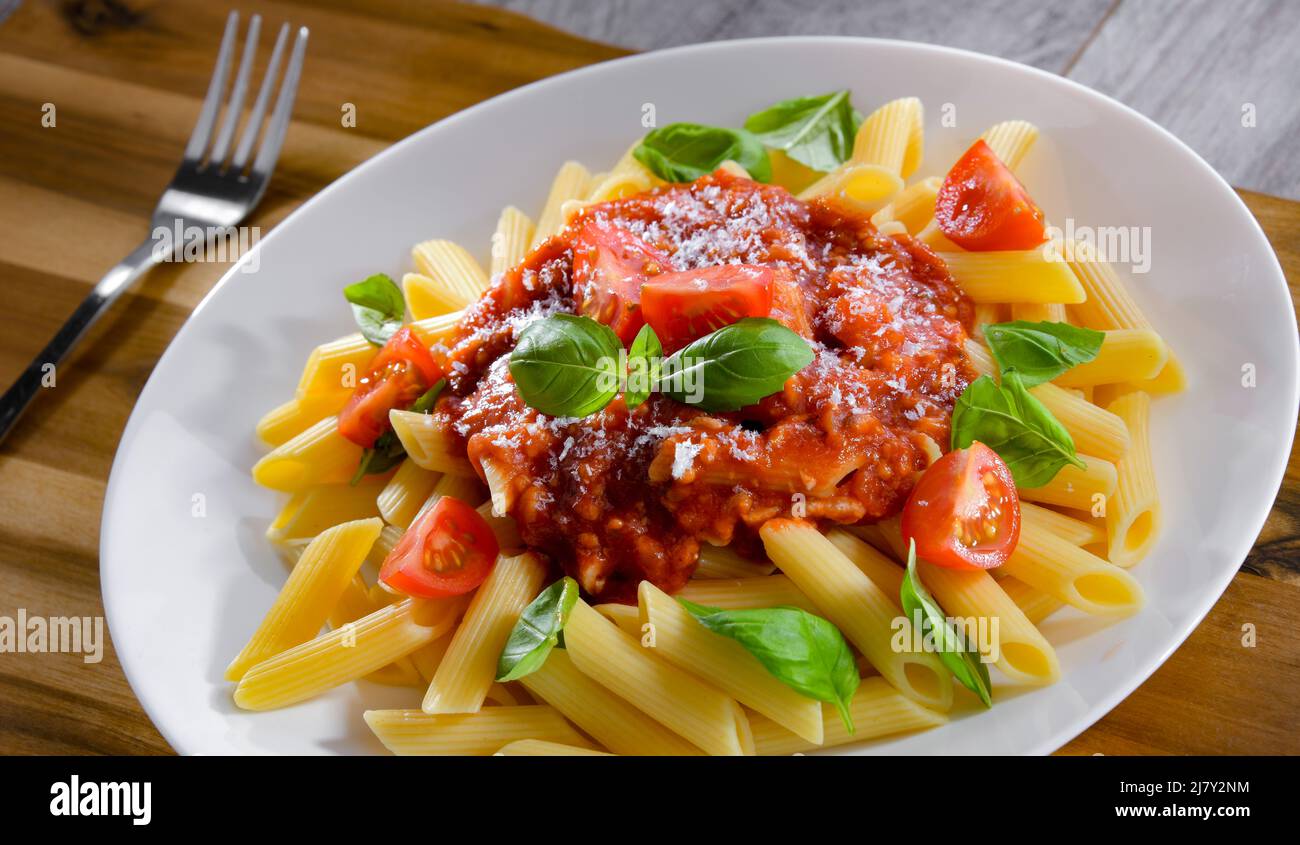 Composition with a plate of pasta penne rigate Stock Photo - Alamy