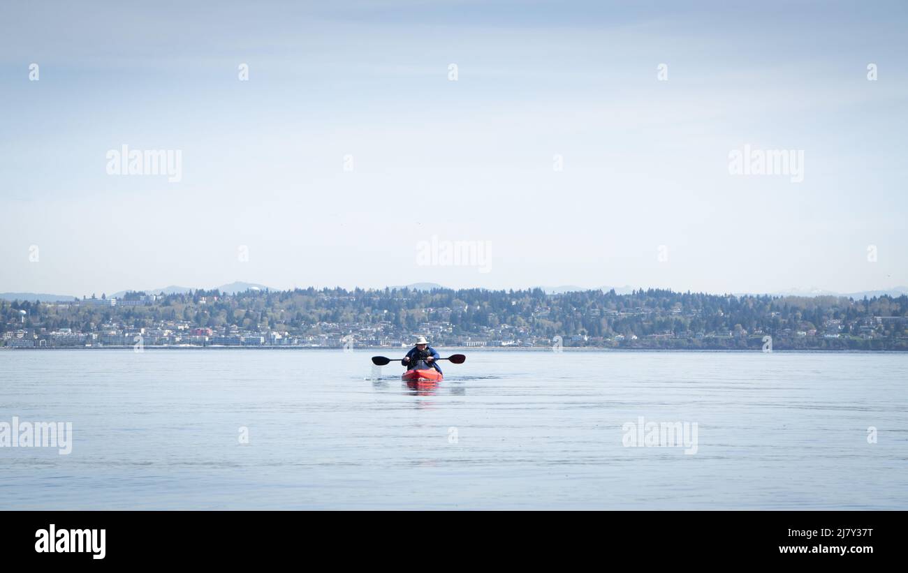 Bright red kayak on a placid Puget Sound Stock Photo - Alamy