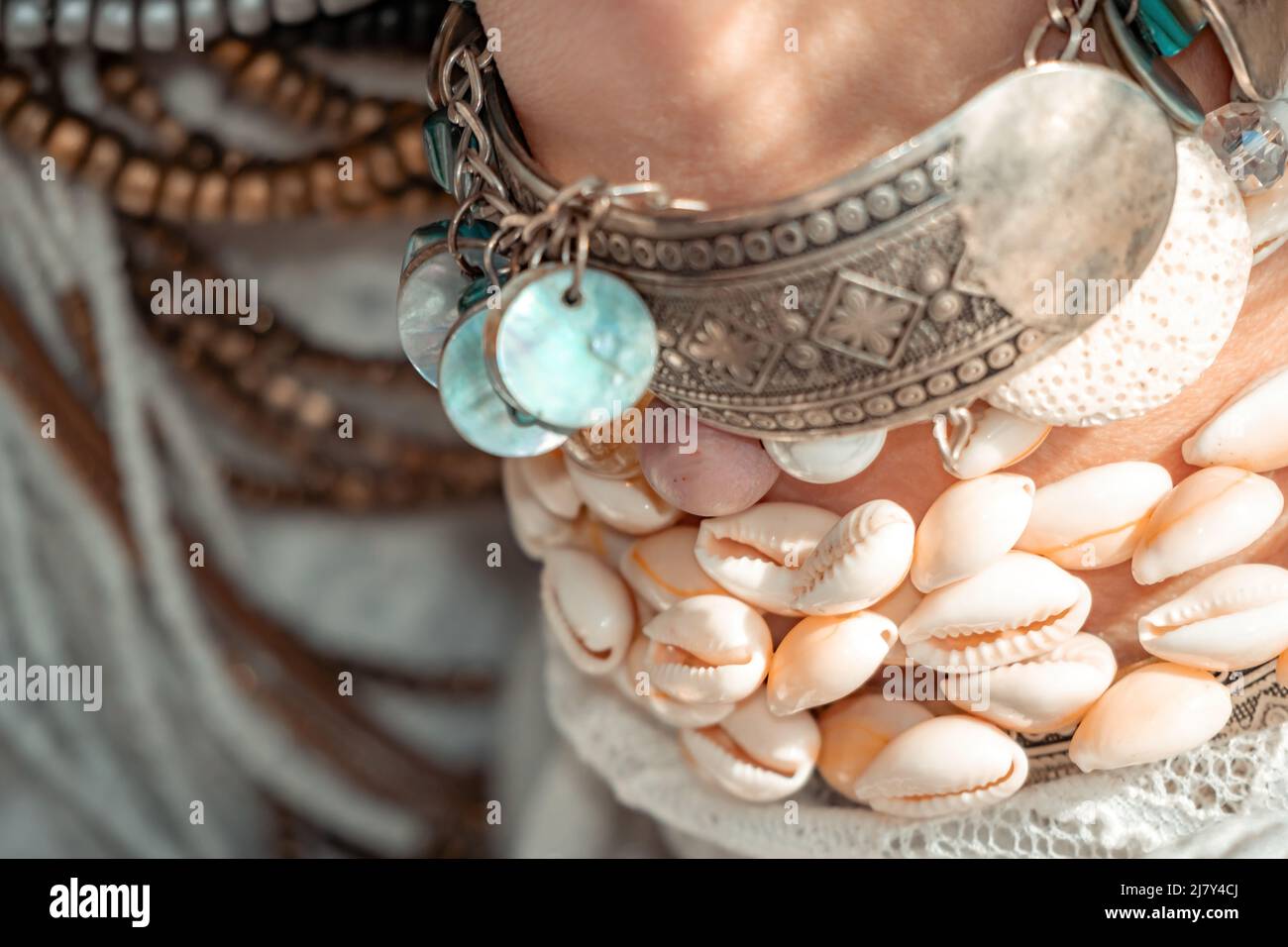 Close up of beautiful tribal boho style woman hands with lots of ...