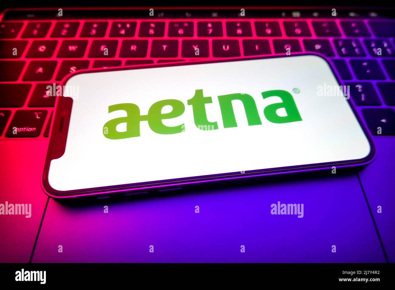 In this photo illustration, an Aetna logo is displayed on the screen of ...