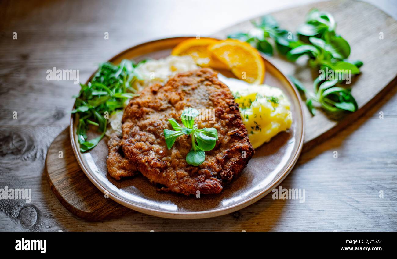 Pork breaded cutlet coated with breadcrumbs with mashed potatoes and ...