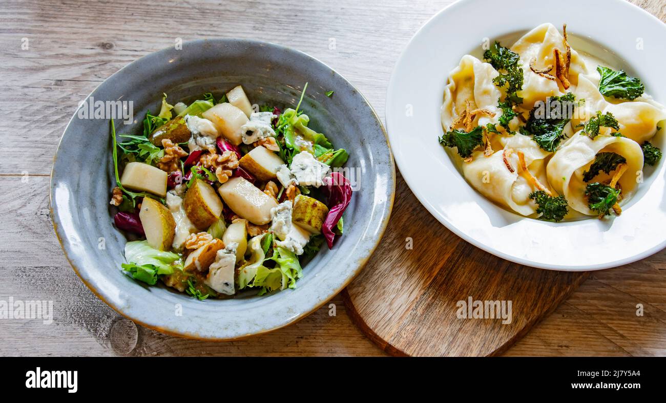 Vegetable salad and traditional East European dumplings, Pierogi Stock ...