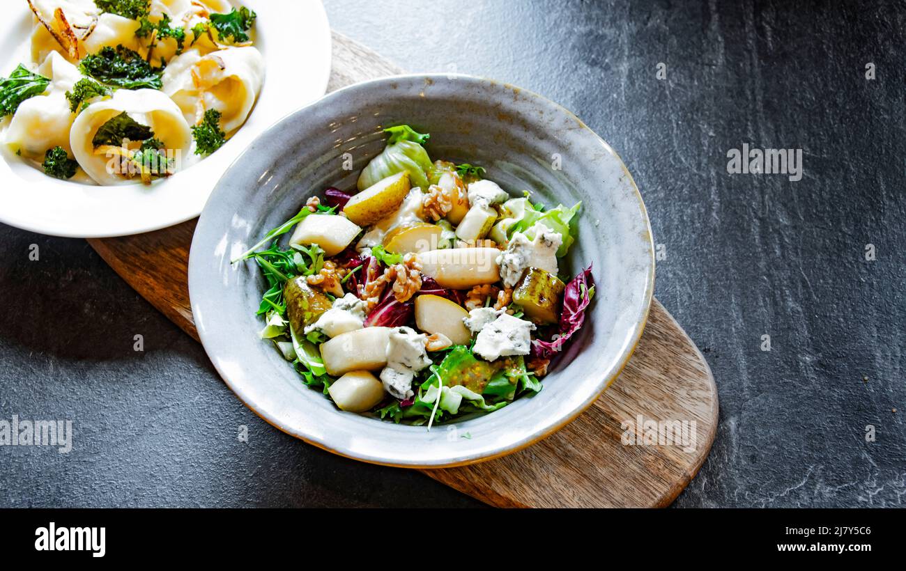 Vegetable salad and traditional East European dumplings, Pierogi Stock ...
