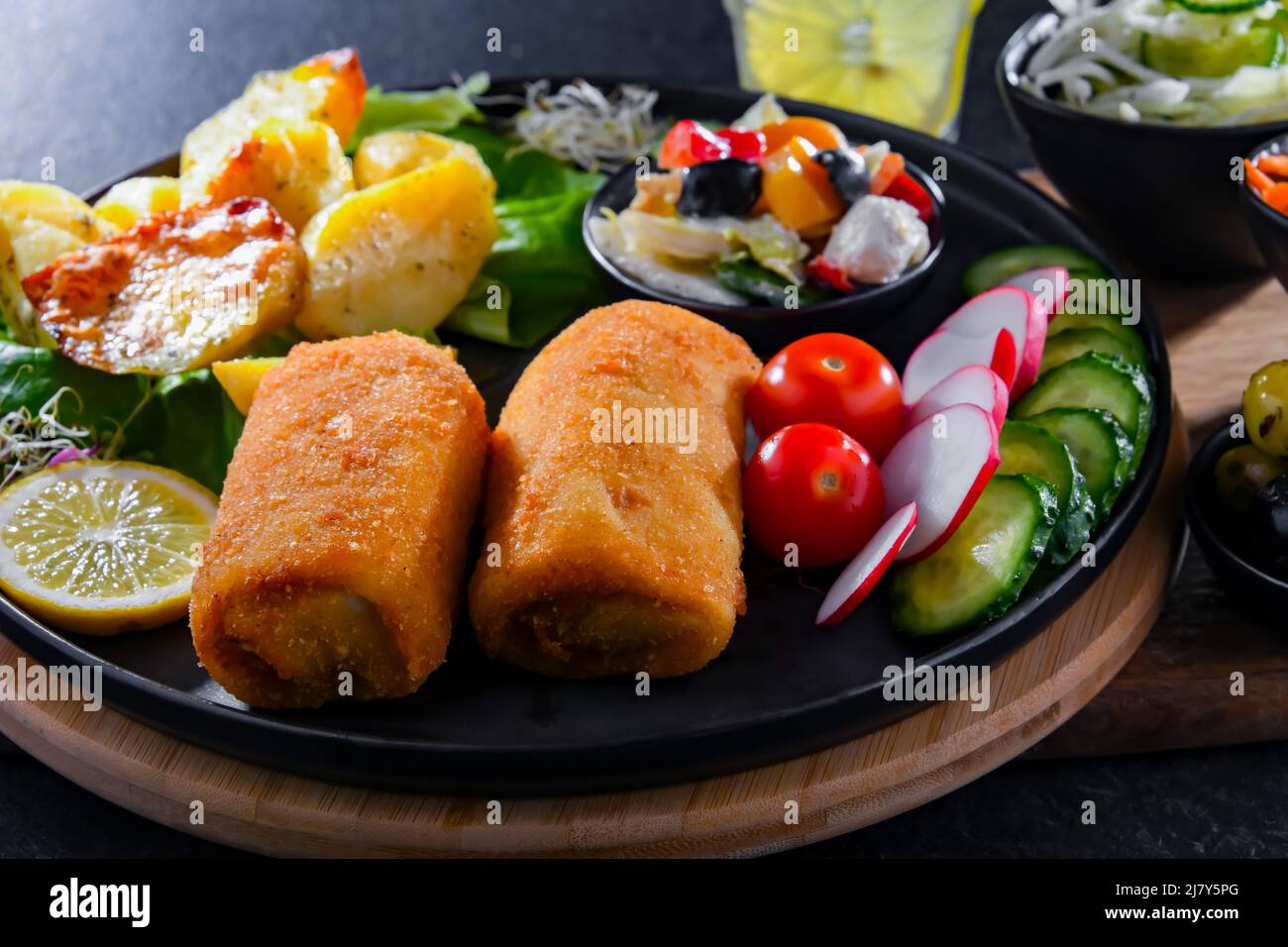 Breaded and deep-fried croquettes with potatoes and vegetable salads ...