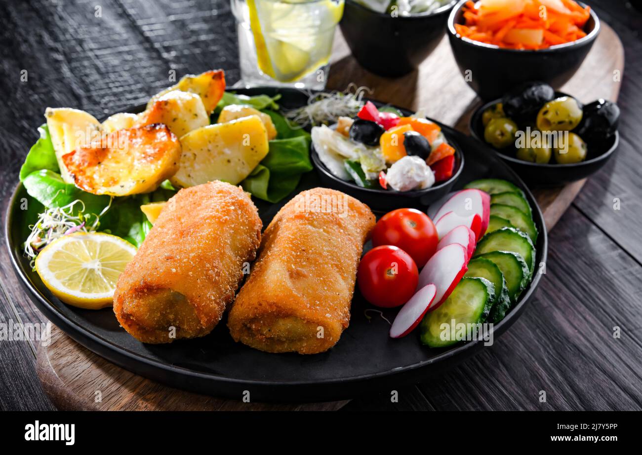 Breaded and deep-fried croquettes with potatoes and vegetable salads ...