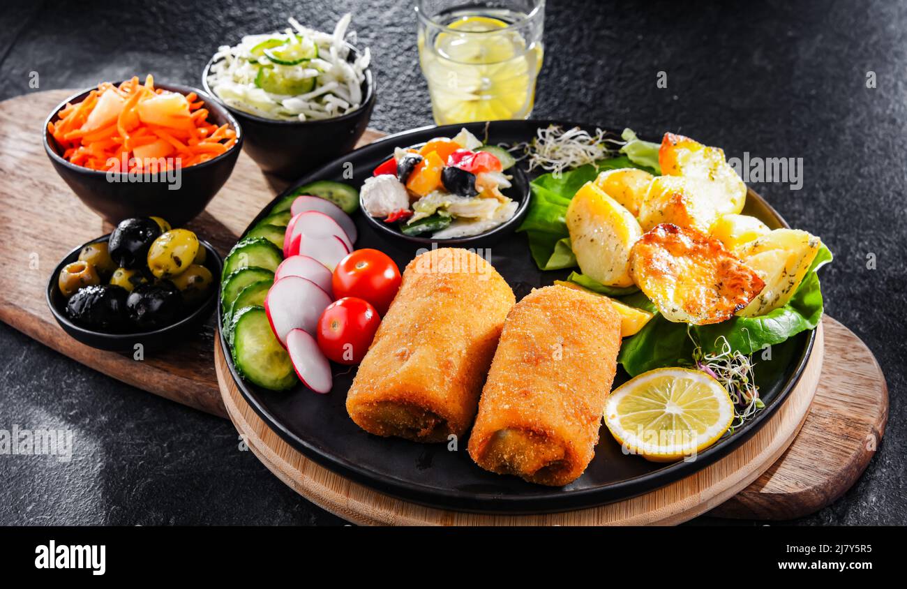 Breaded and deep-fried croquettes with potatoes and vegetable salads ...