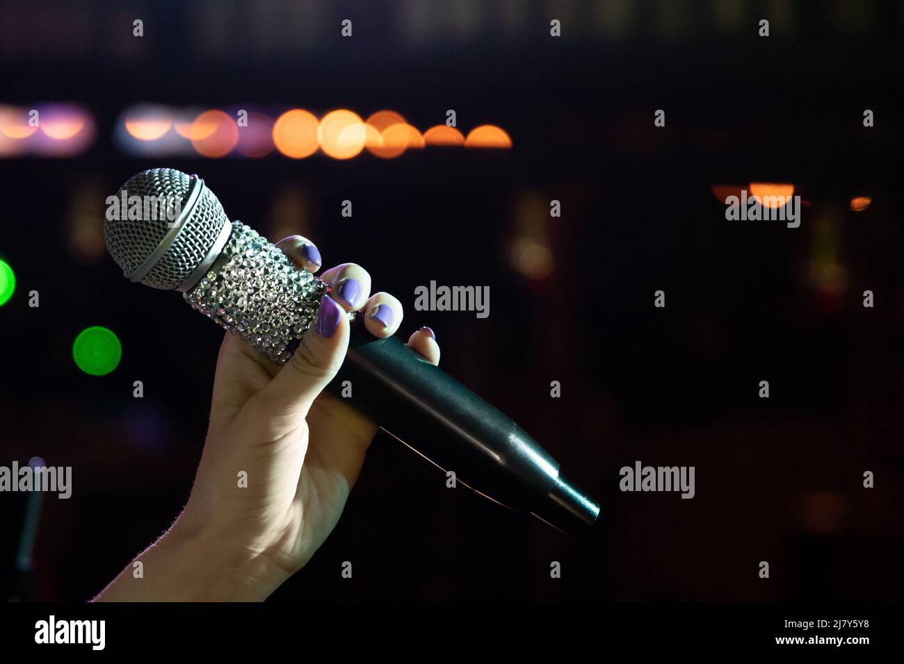 Holding microphone on stage person hi-res stock photography and images ...